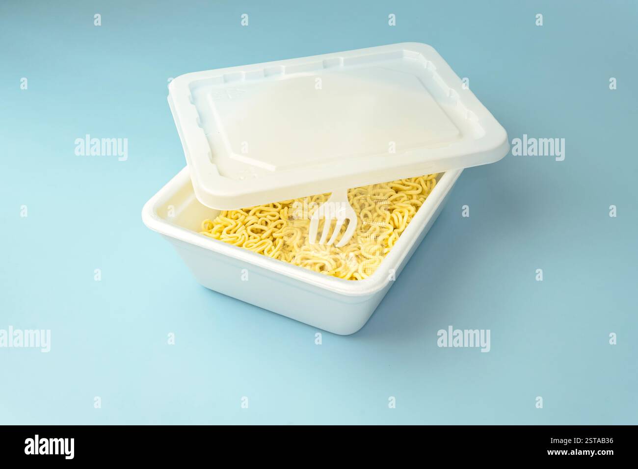White box of noodles on an blue background, fast cheap food. Chinese ...