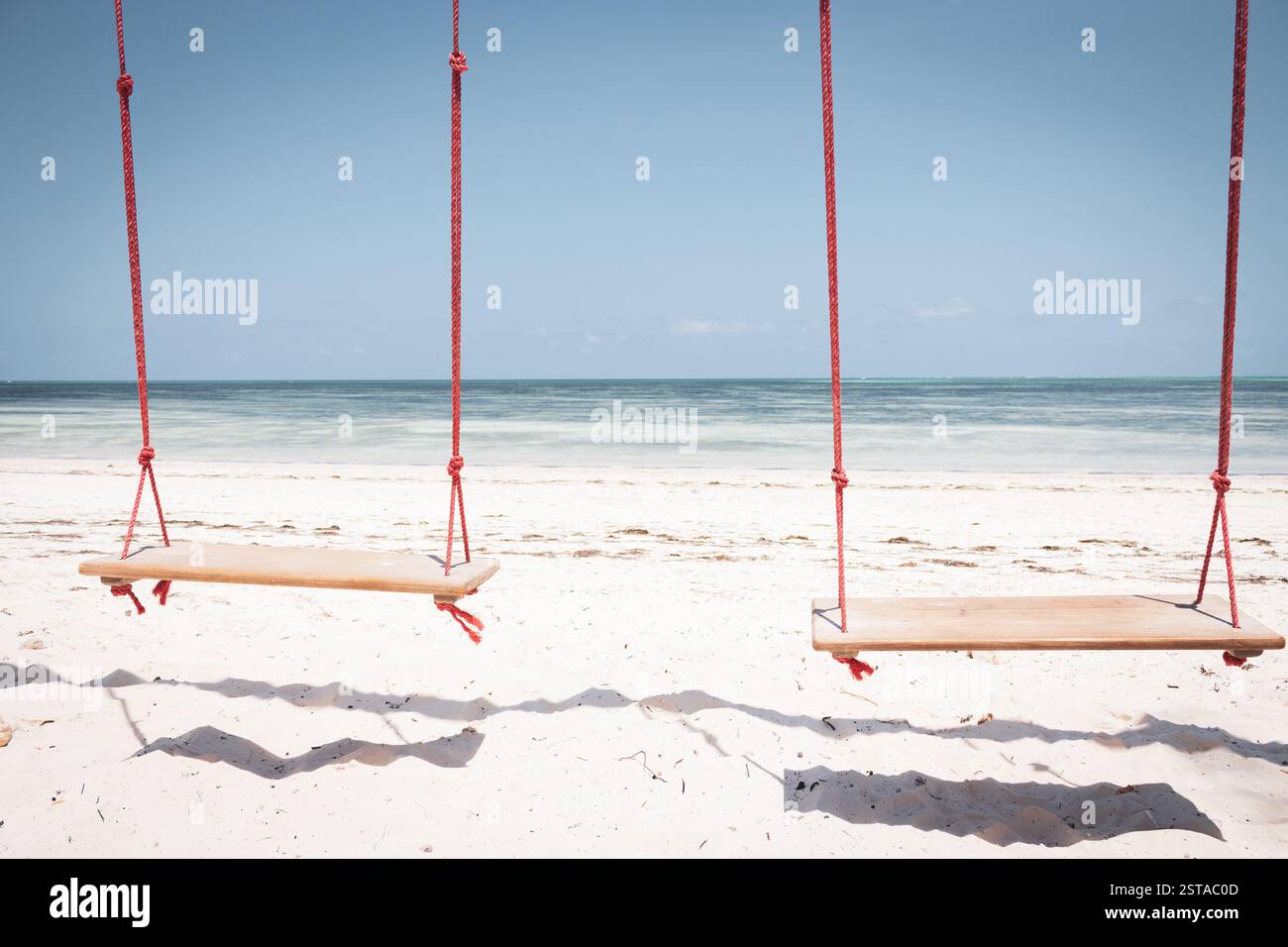 Wooden swing on the beach. Swing with two seats on scenic seascape ...