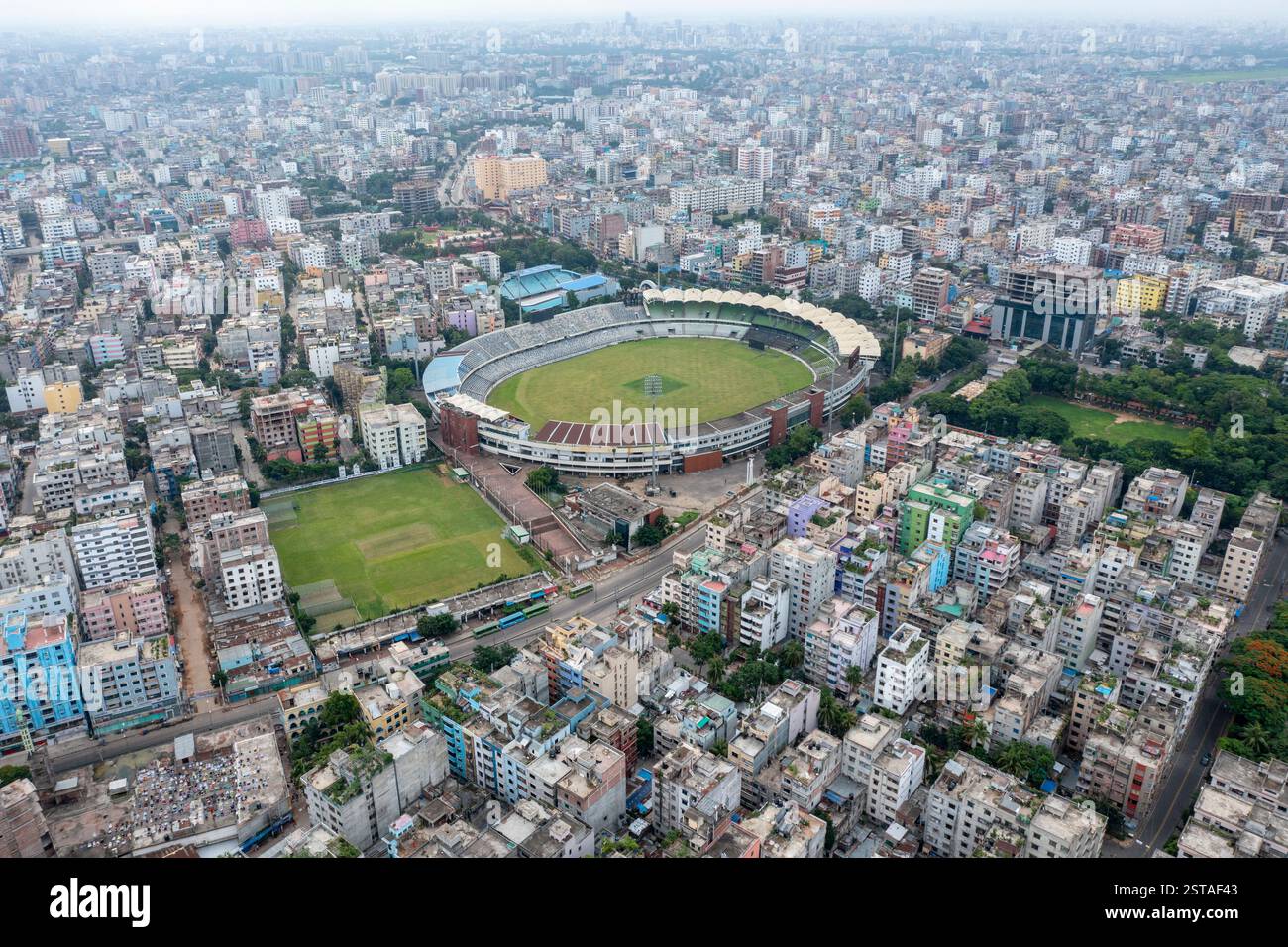 A stunning aerial view of the Sher-e-Bangla National Cricket Stadium, surrounded by the vibrant ...