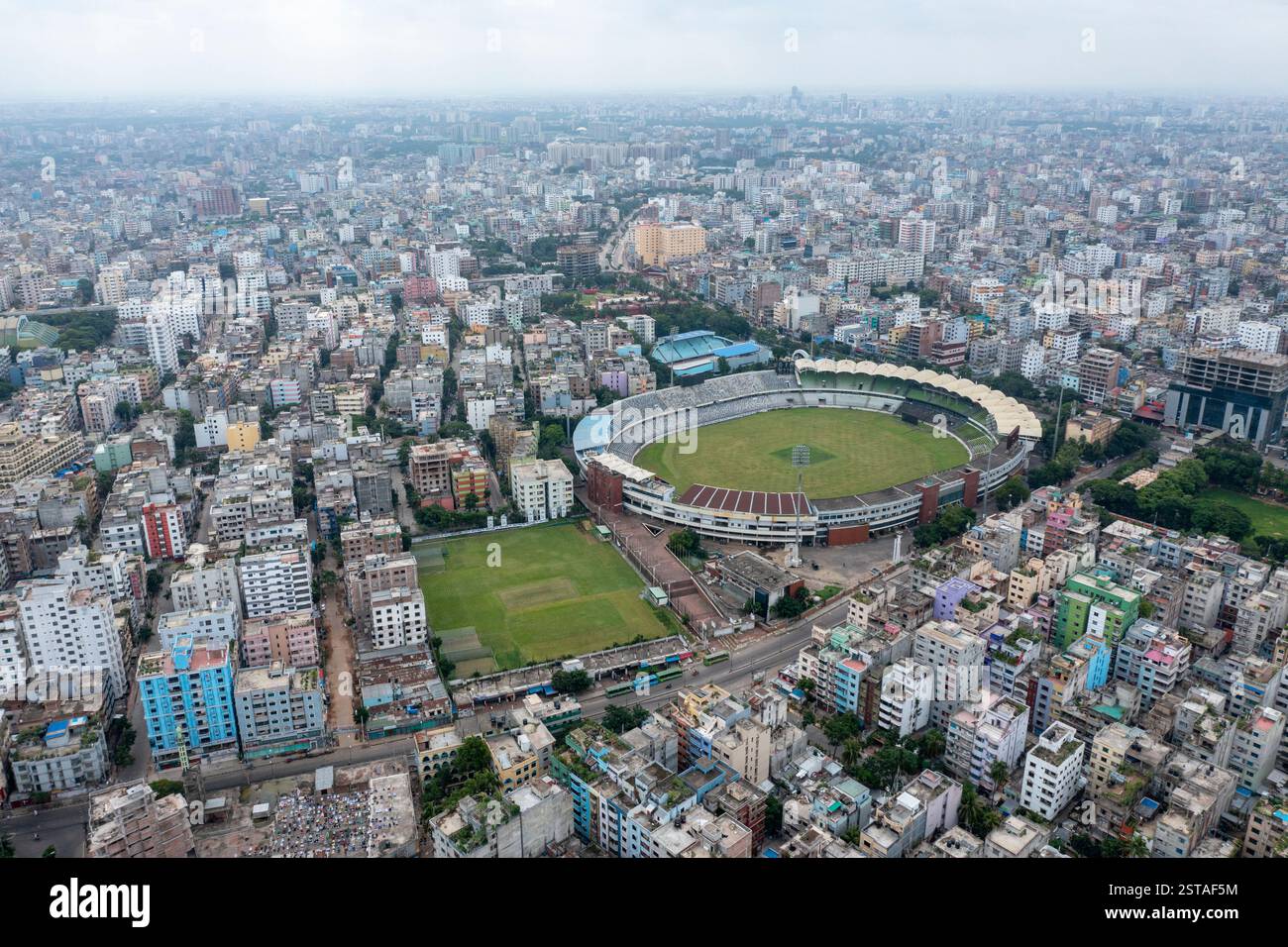 A stunning aerial view of the Sher-e-Bangla National Cricket Stadium, surrounded by the vibrant ...