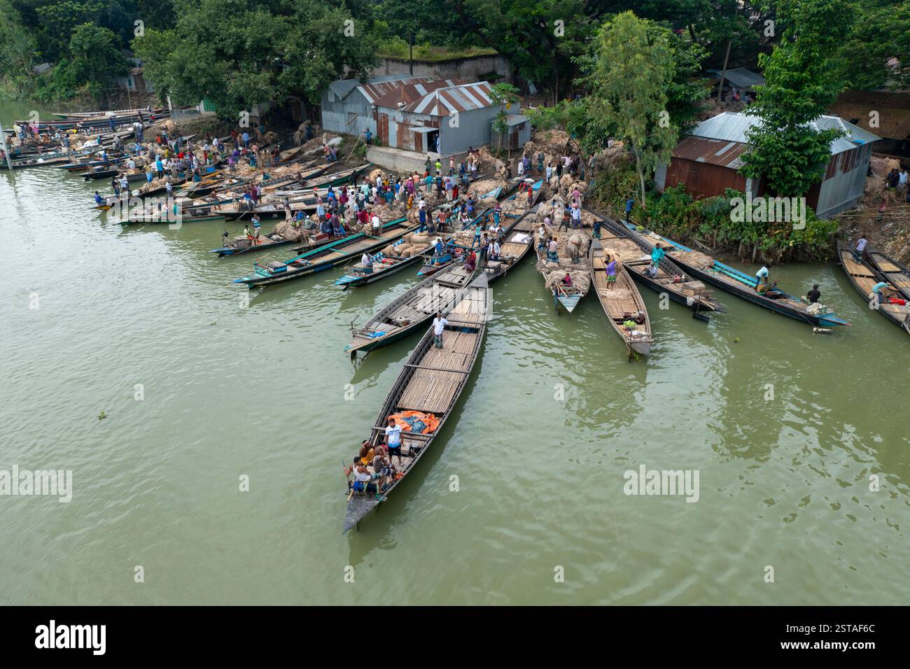 An aerial view of boats laden with raw jute fibers anchored at the ...