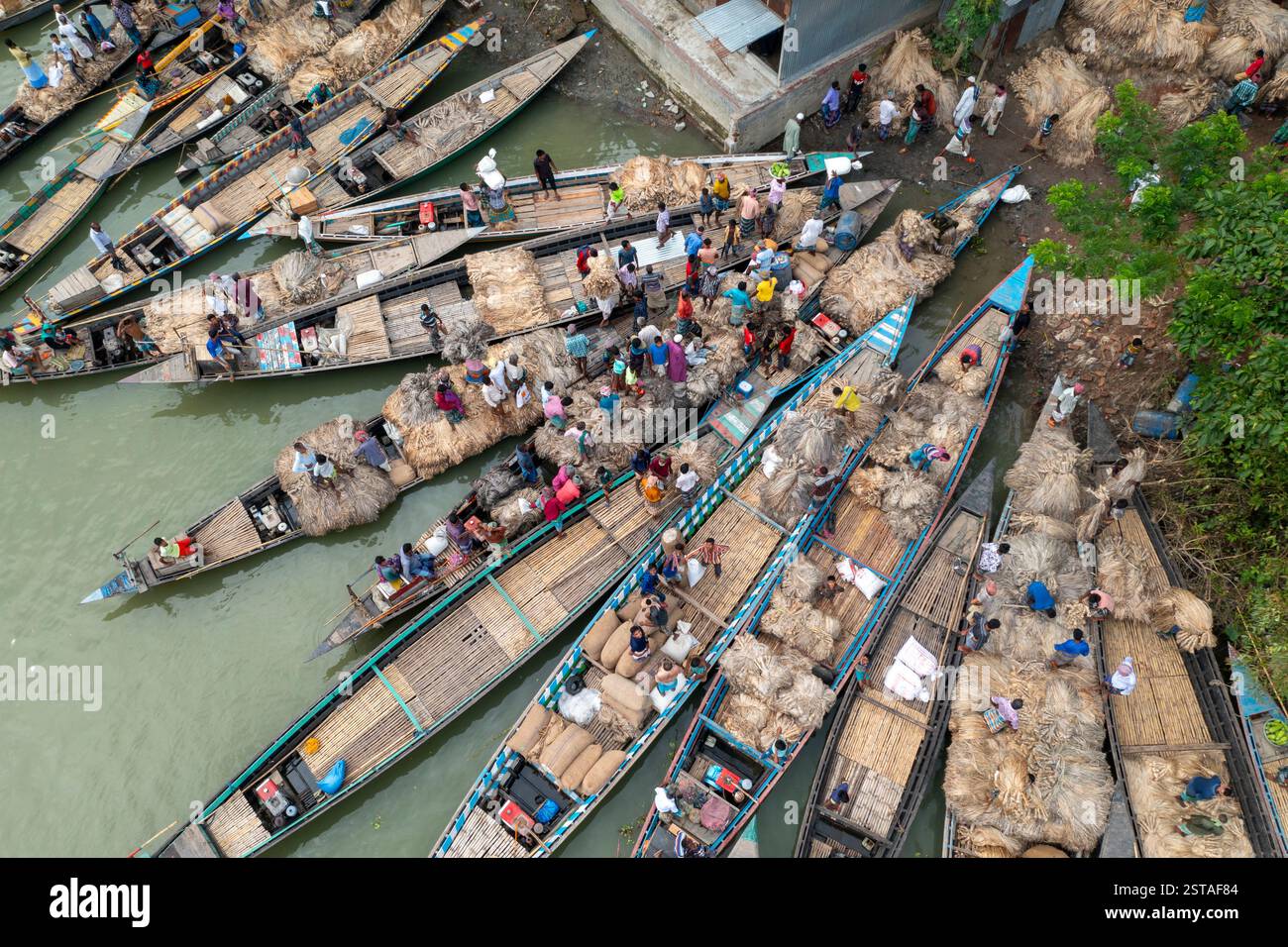 An aerial view of boats laden with raw jute fibers anchored at the ...