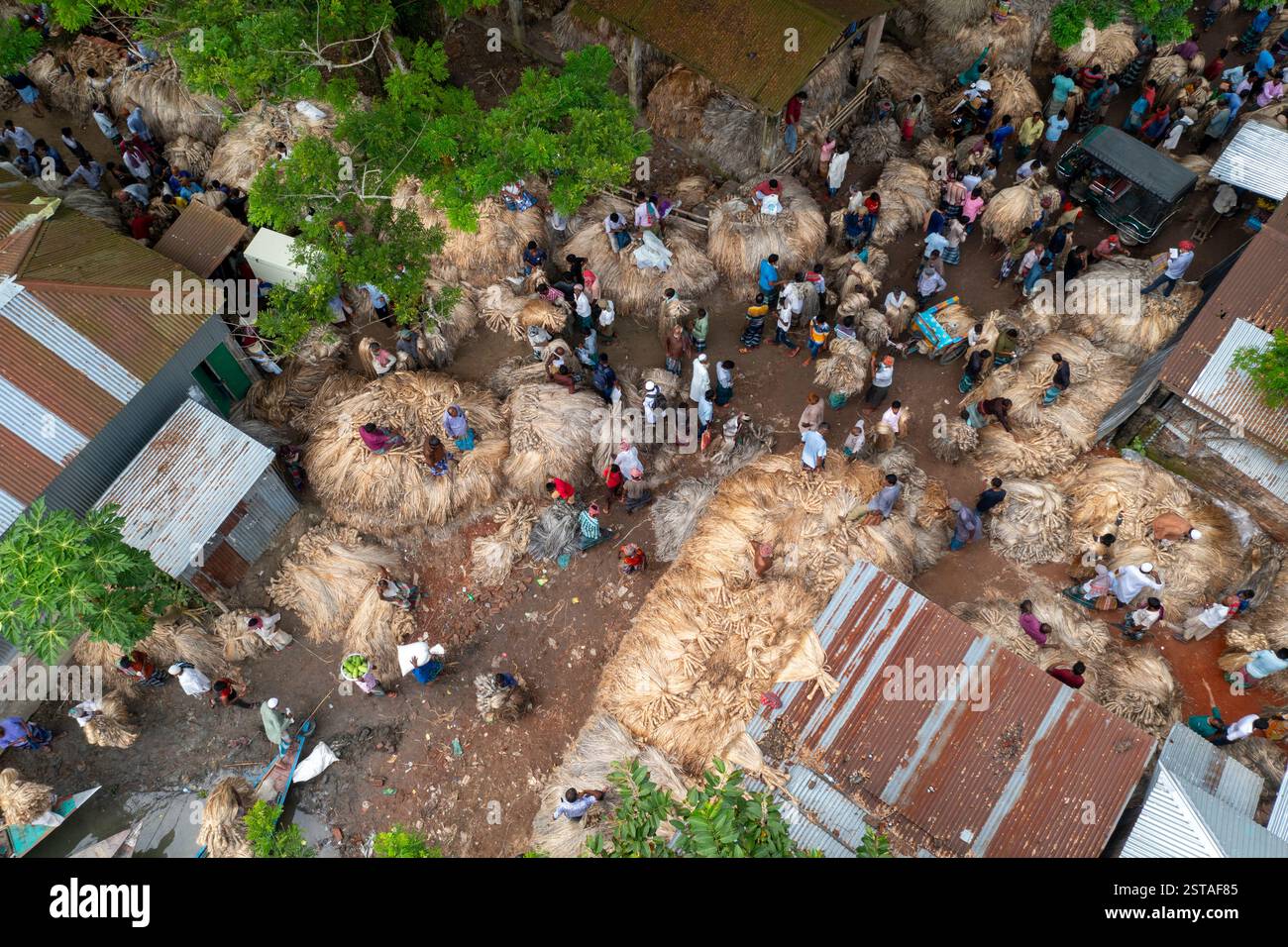 An aerial view shows traders and buyers actively engaged in trading raw ...
