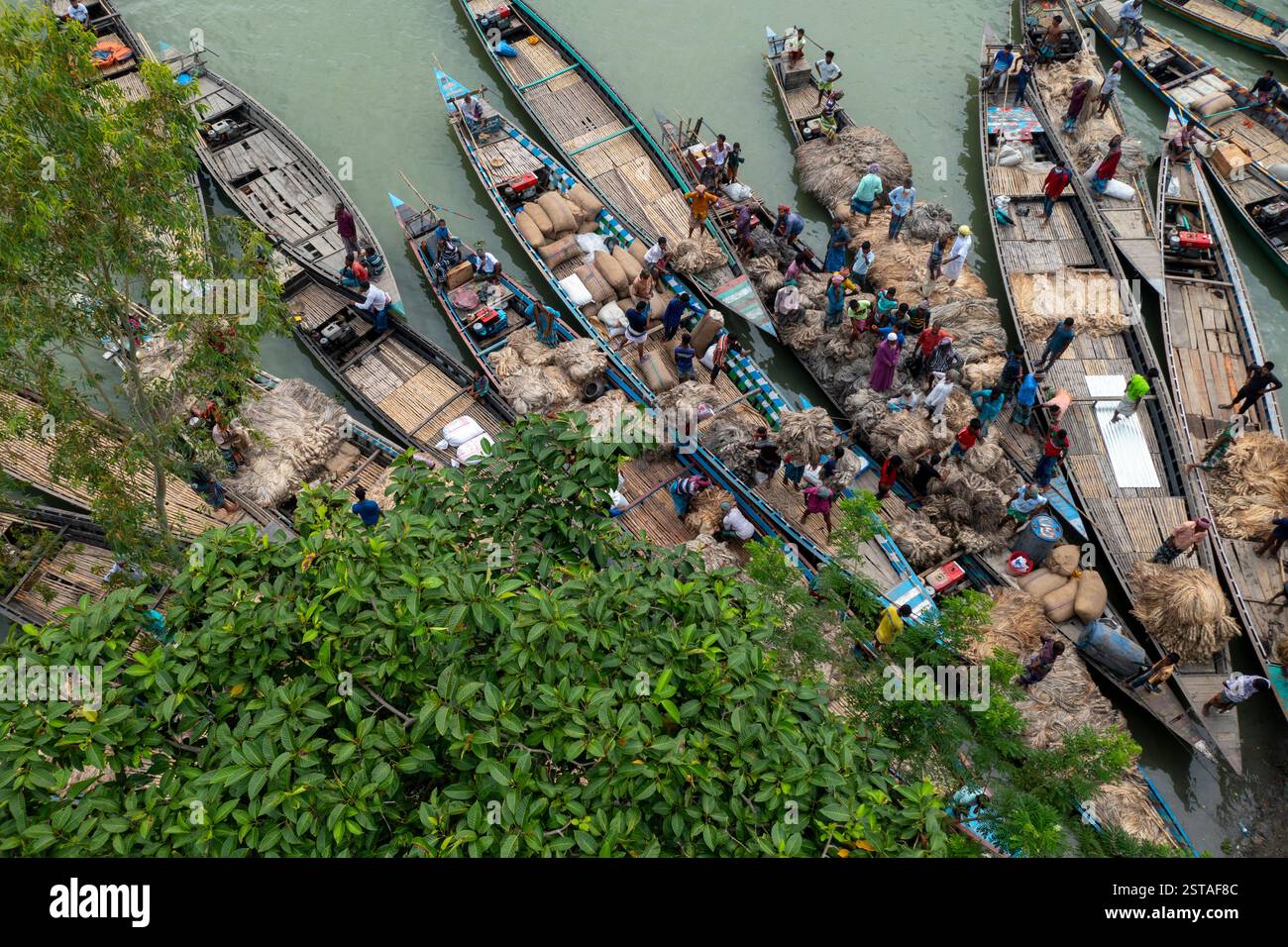 An aerial view of boats laden with raw jute fibers anchored at the ...