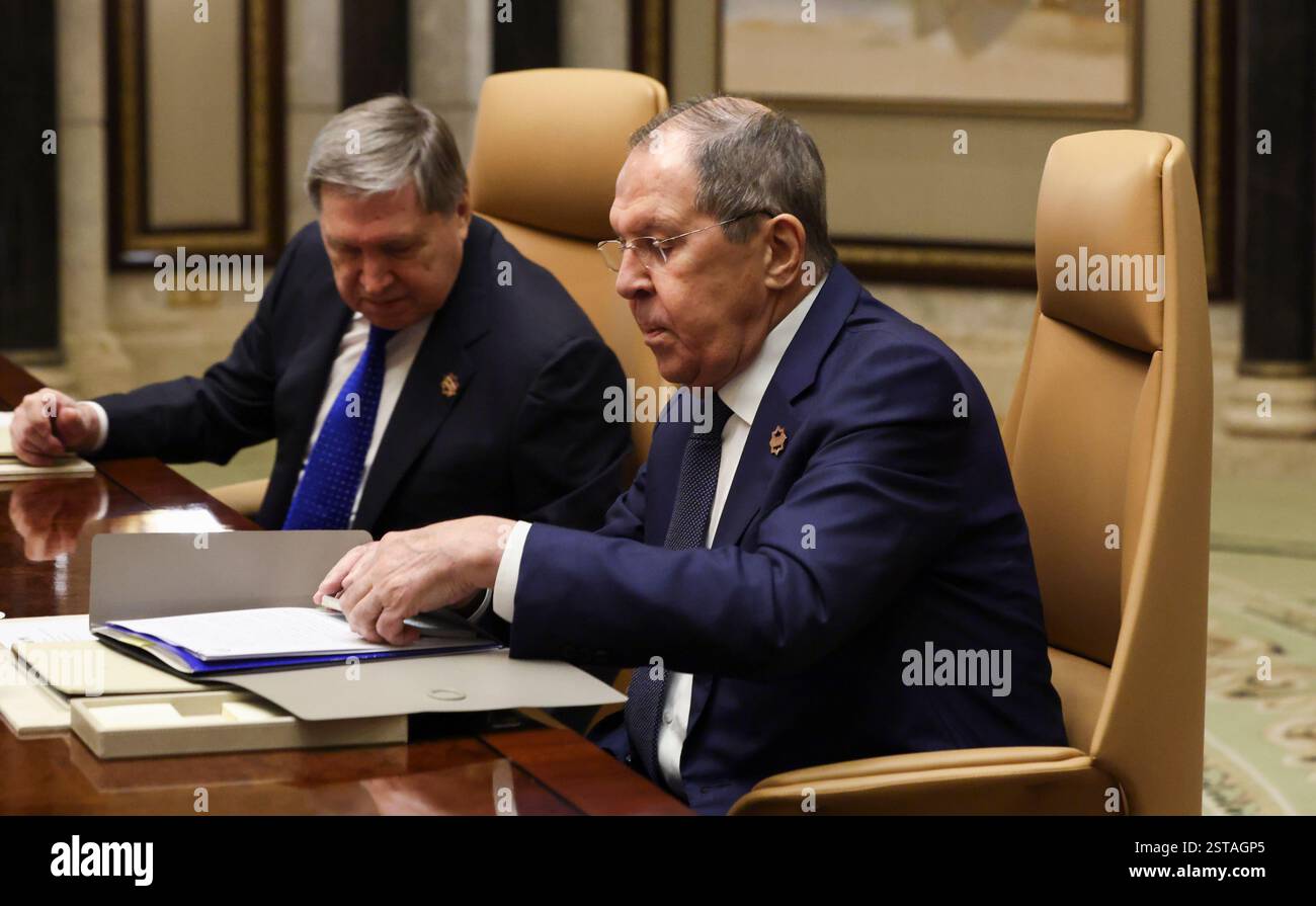 Russian Foreign Minister Sergei Lavrov, right, sits next to Russian ...