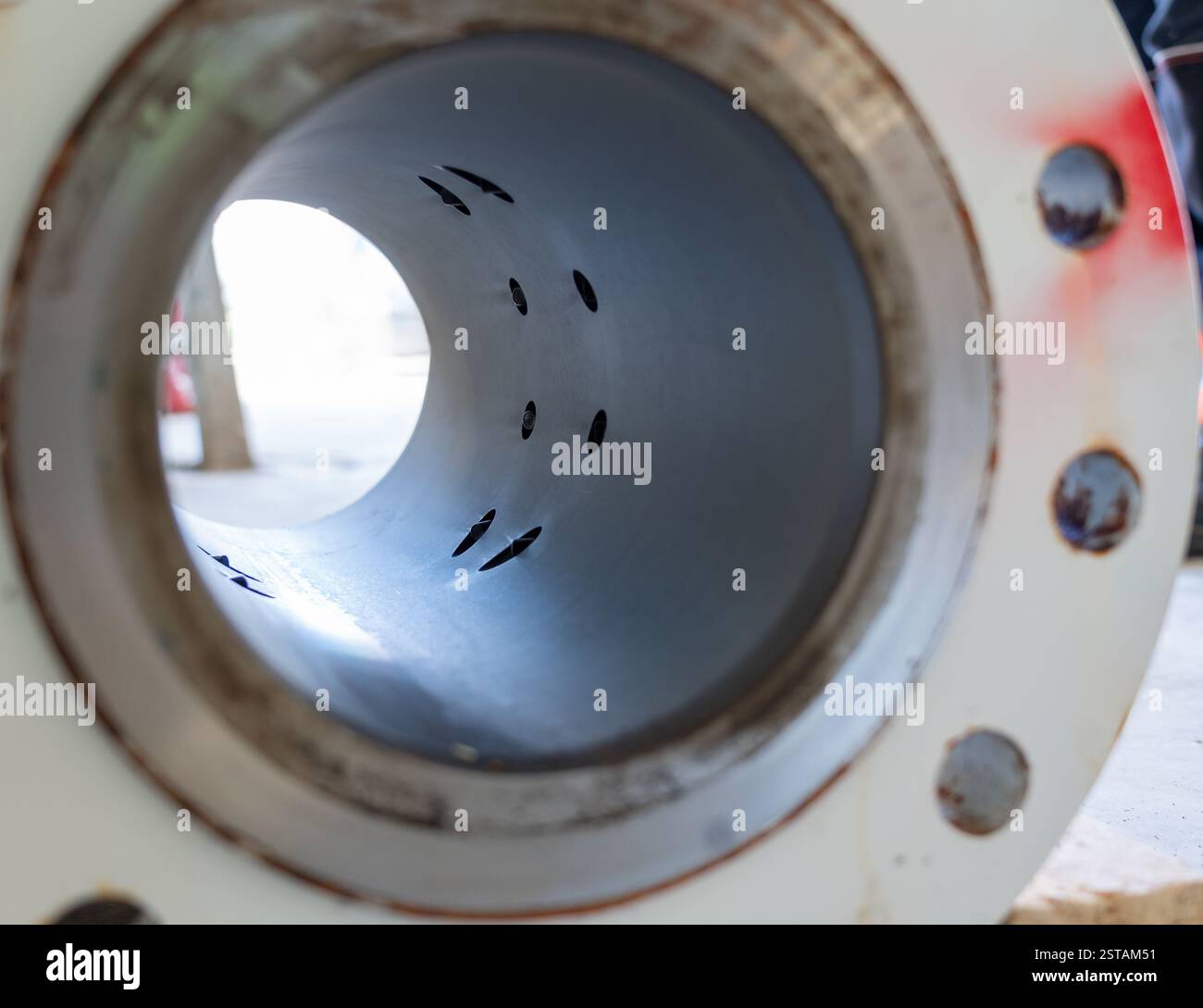 Internal view of an ultrasonic flow meter showing sensor mounting holes ...