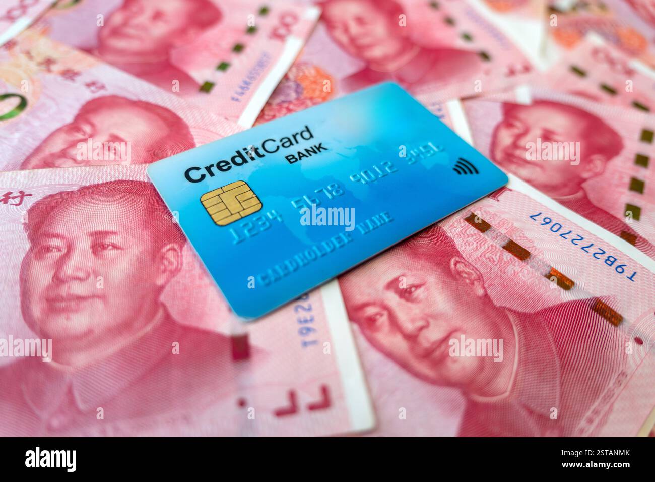 Credit cards and dollar bills. a blue plastic bank card is lying on a ...