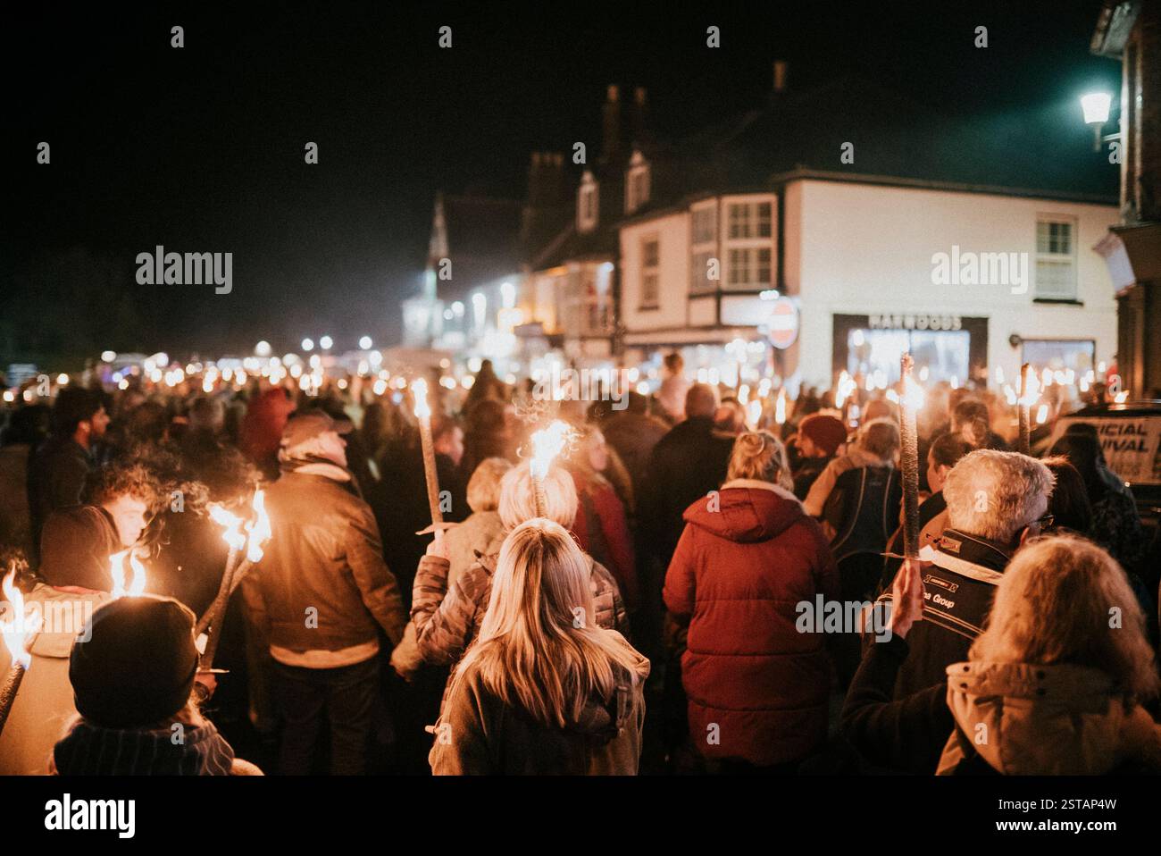 A large crowd of people are gathered in front of a building, holding ...