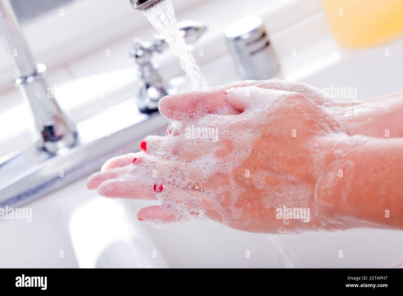 Woman Washing Hands in the Kitchen Sink Stock Photo - Alamy