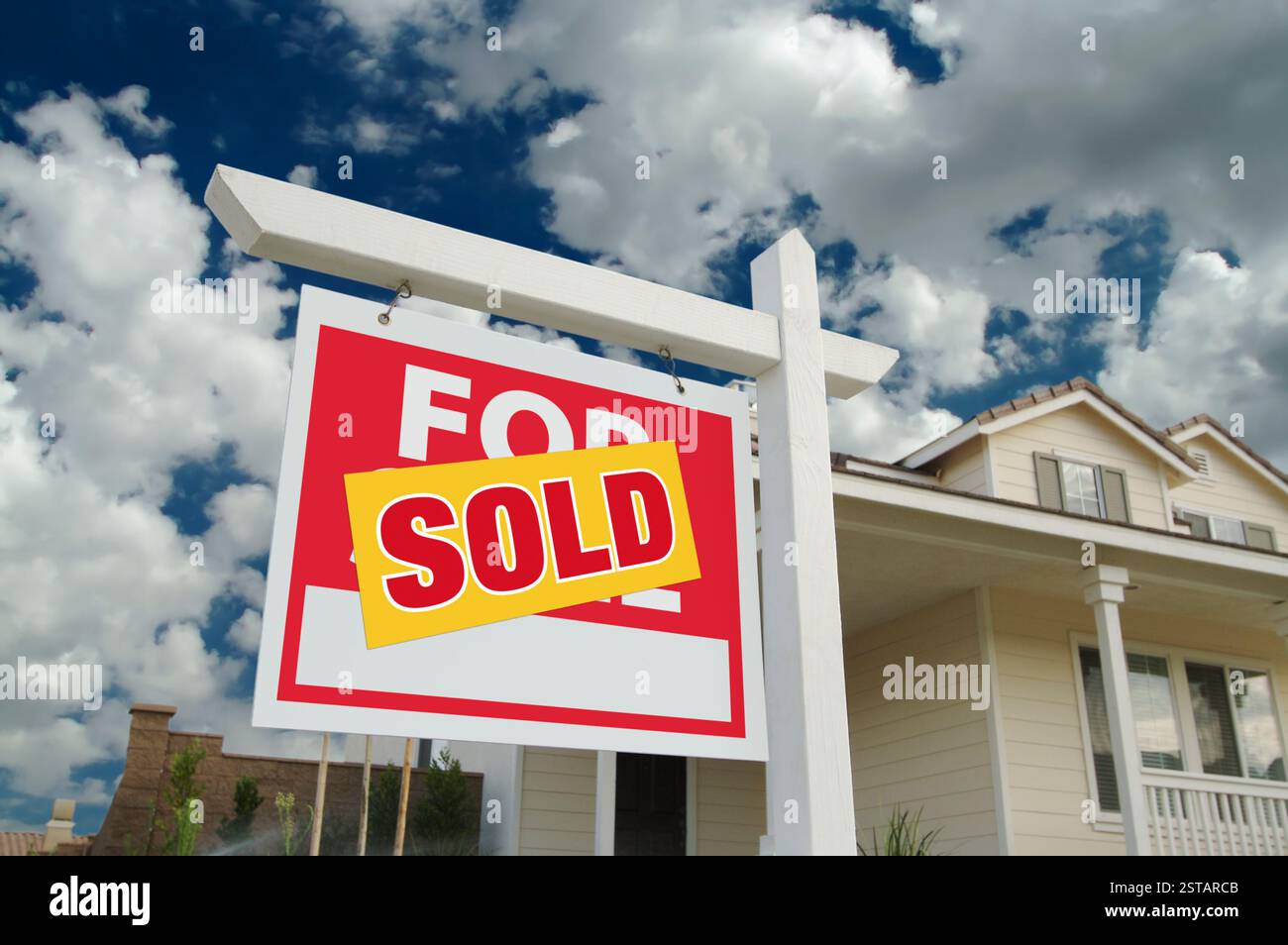 Sold Home For Sale Sign in Front of New House Stock Photo - Alamy
