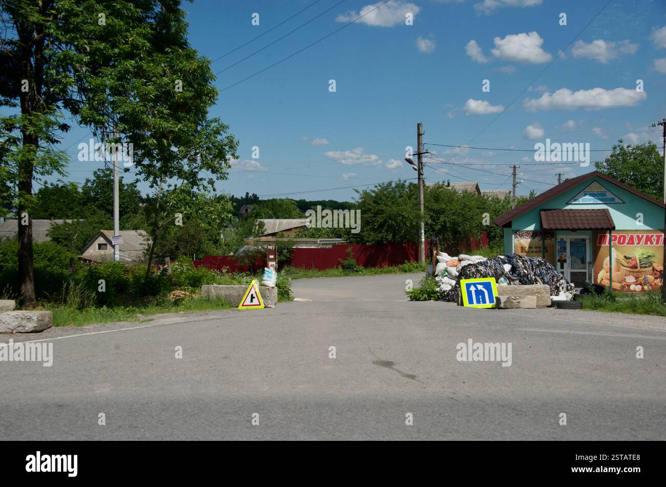 Photo shows a road block/security checkpoint at the entrance to a ...