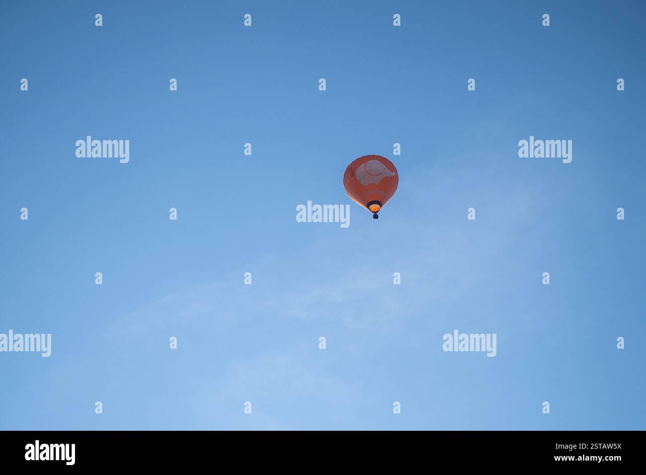 Orange Hot Air Balloon Floating in Blue Sky Stock Photo - Alamy