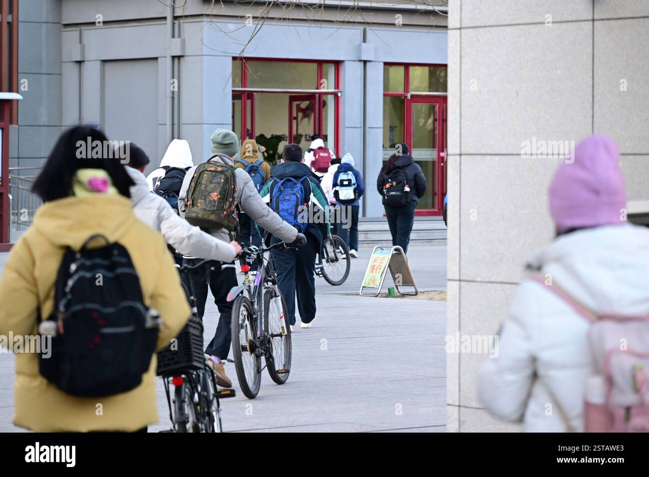 Beijing,China.17th February 2025. Students walk into the school campus ...