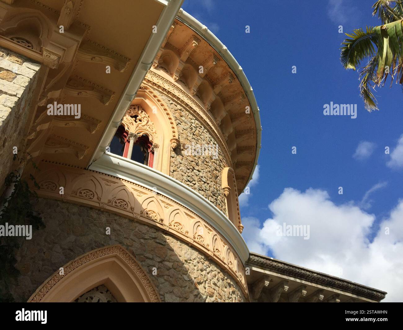 Building yellow stucco exterior ornate detailing stone base arched ...