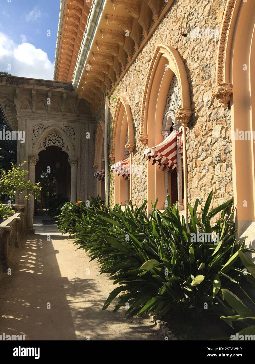 Palace. Stone exterior with arched windows and ornate detailing. Lush ...