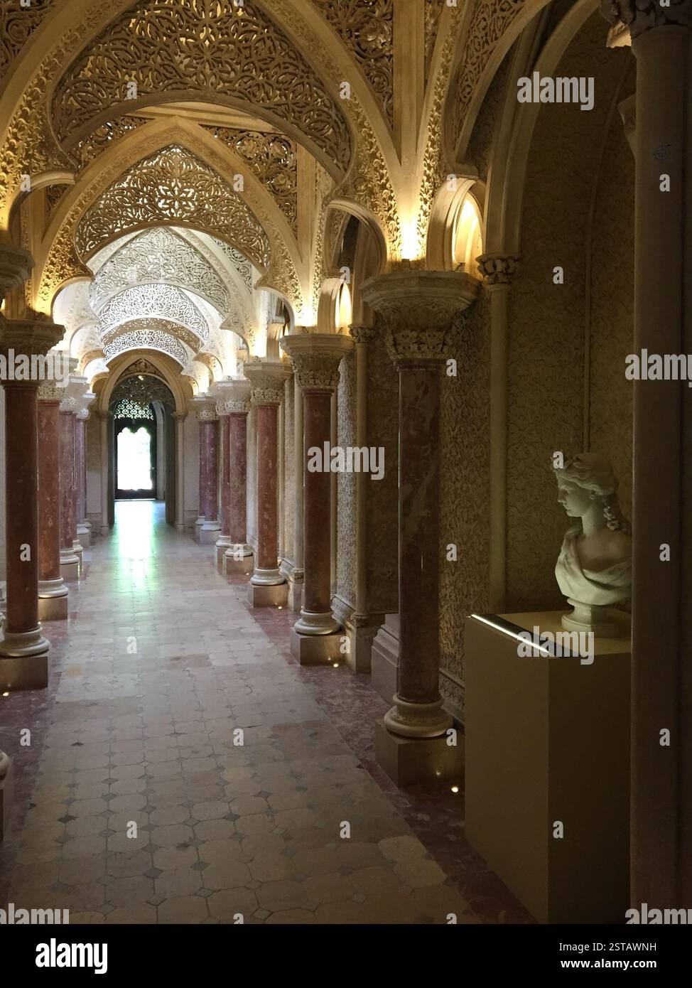 Corridor. Ornate arched ceiling, intricate gold patterns, and red ...