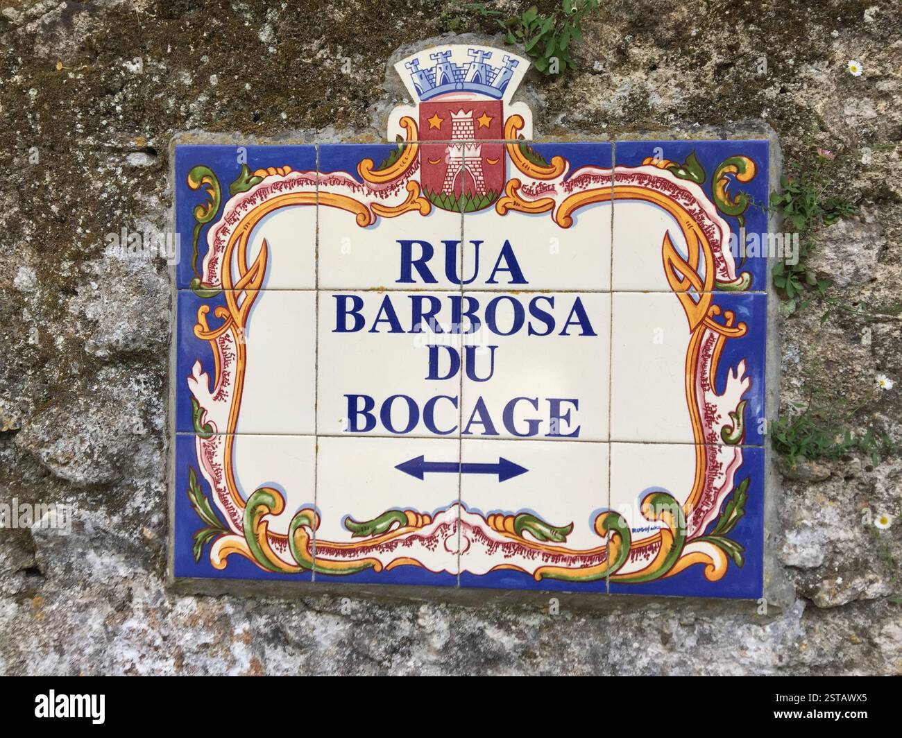 Sign. Ceramic tiles with blue, yellow, and white colors. Street name in ...