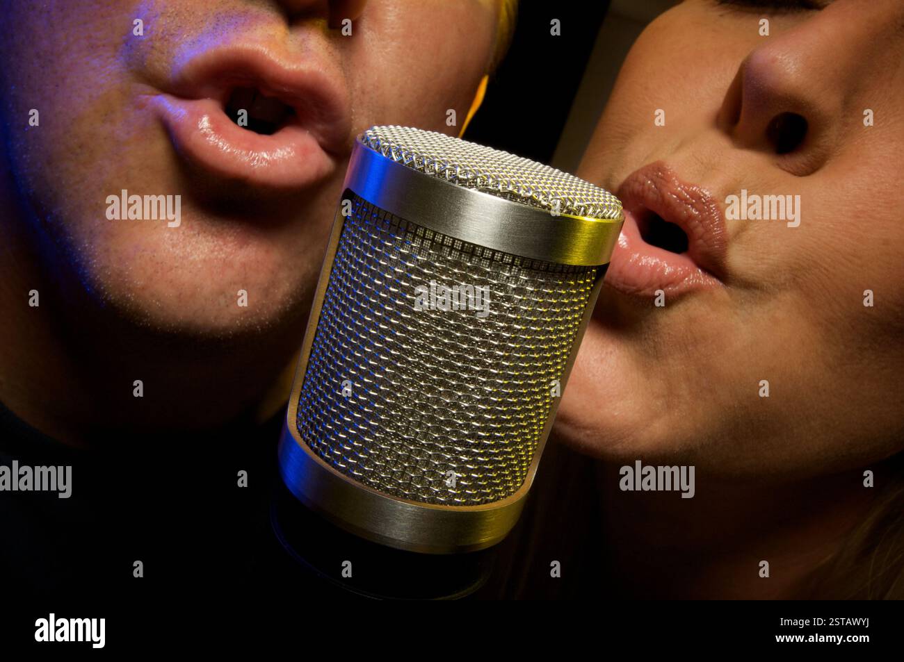 Couple singing duet at condenser microphone hi-res stock photography ...