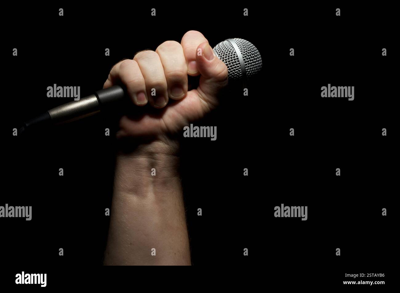 Microphone in Fist Stock Photo - Alamy