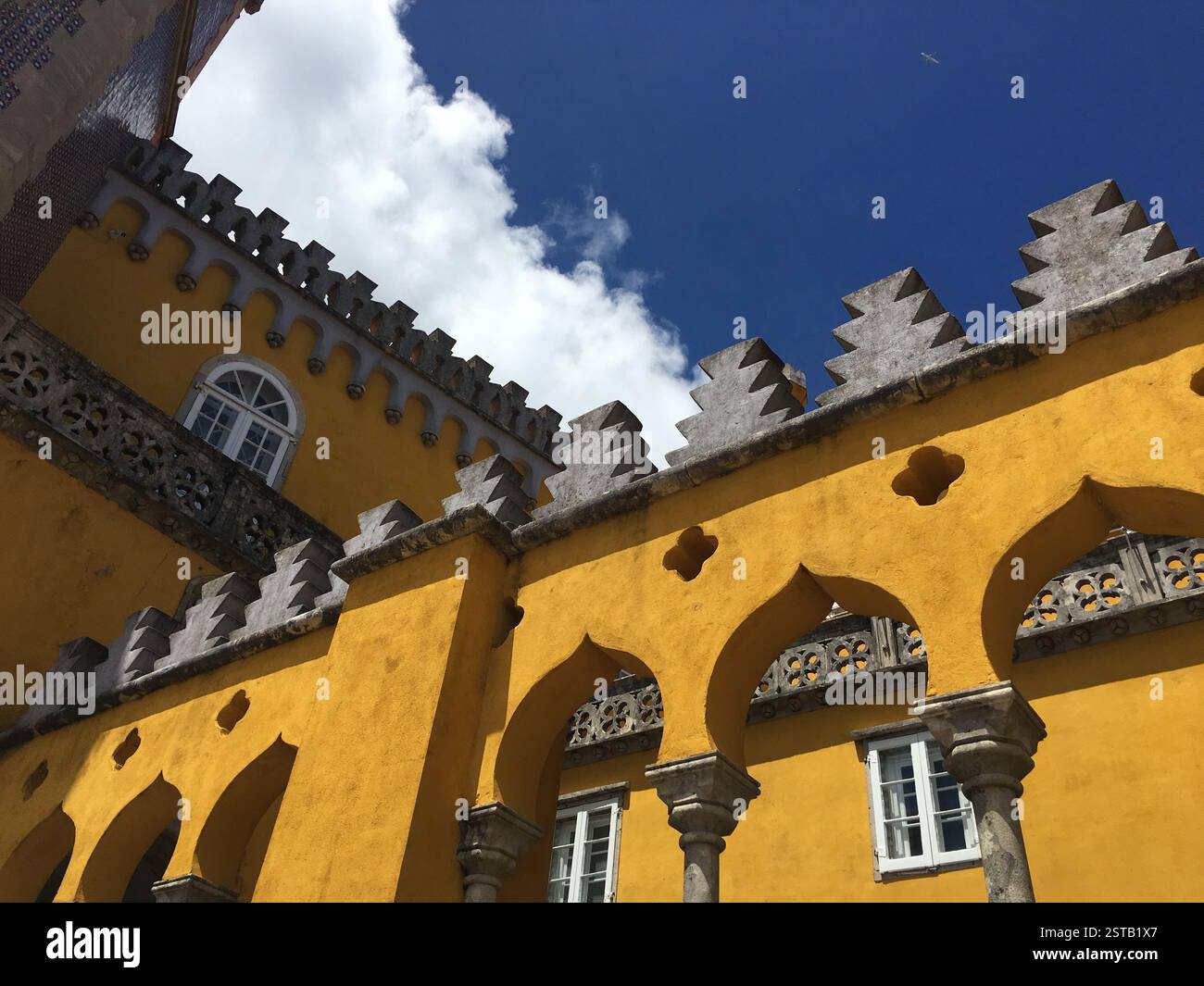 Pena Palace. Bright yellow facade with intricate Moorish arches and ...