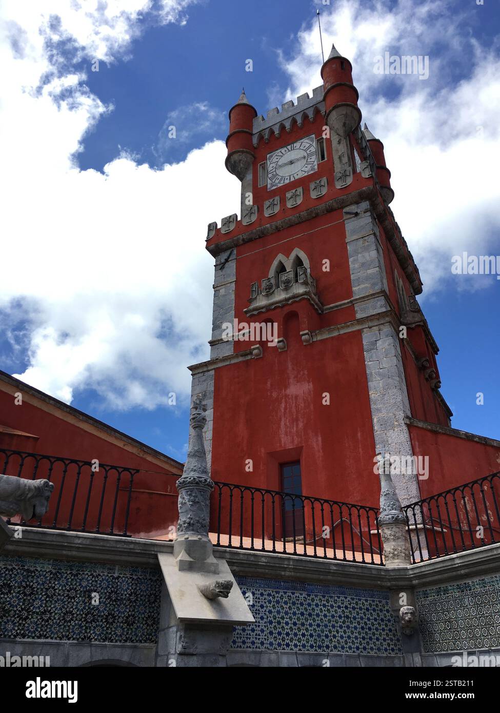 Pena Palace. Bright red tower with clock, intricate detailing, blue sky ...