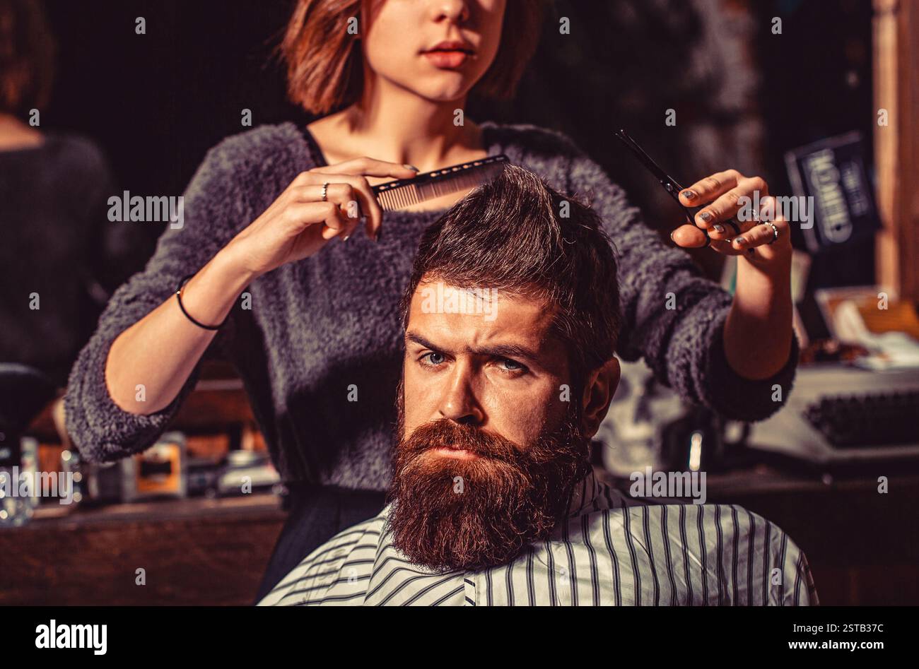 Woman barber undercut hairstyle using scissors. Girl barber making ...