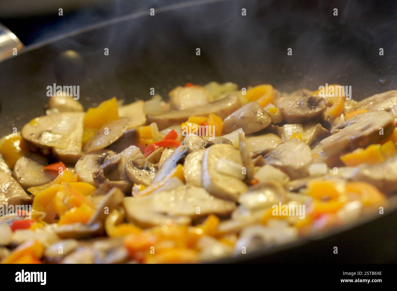 Mushroom and Vegetable SauteÌ with Steam and narrow depth of field ...