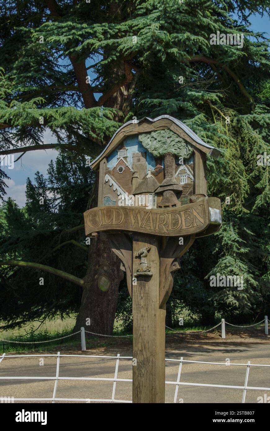 Carved wooden and painted village sign, depicting local attractions ...