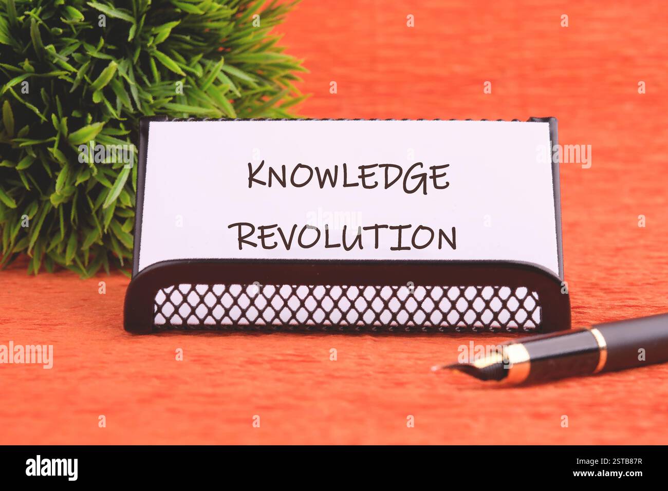 A business card displays the phrase knowledge revolution, highlighting ...