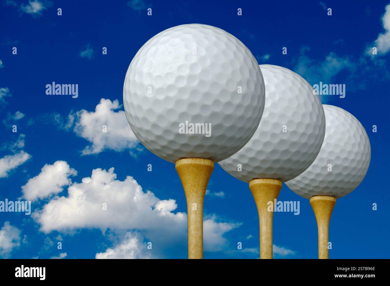 Three Golf Balls & Tees on the left with clouds and sky background ...