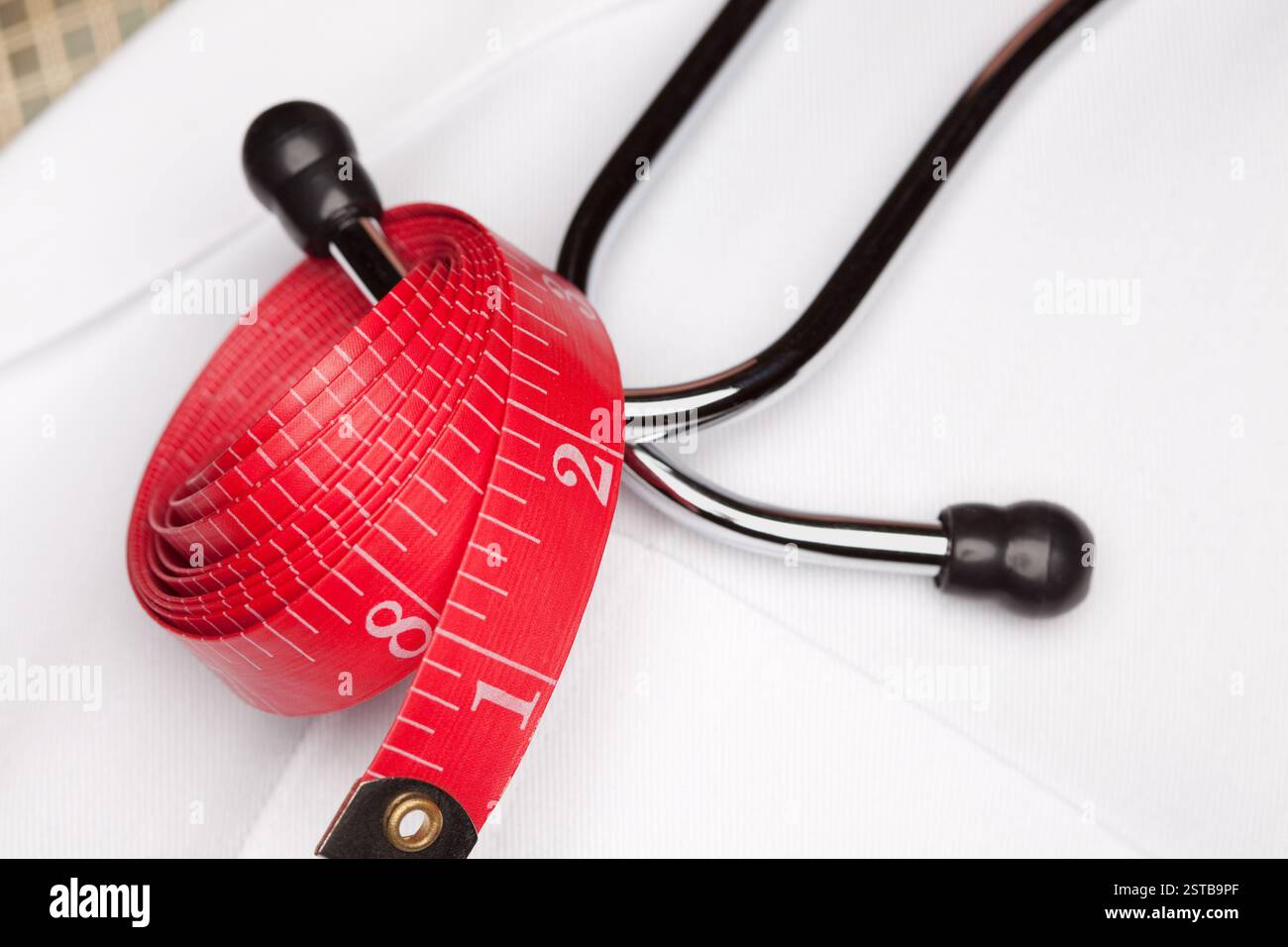 Doctor with Stethoscope and Red Measuring Tape Stock Photo - Alamy