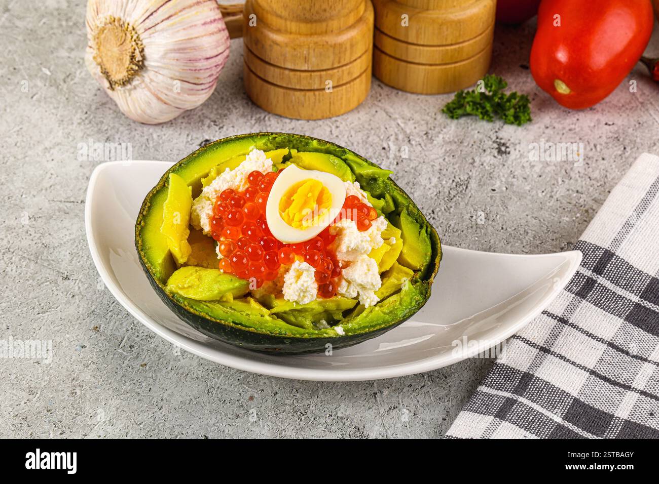 Avocado with red caviar and quil egg and soft cheese Stock Photo - Alamy
