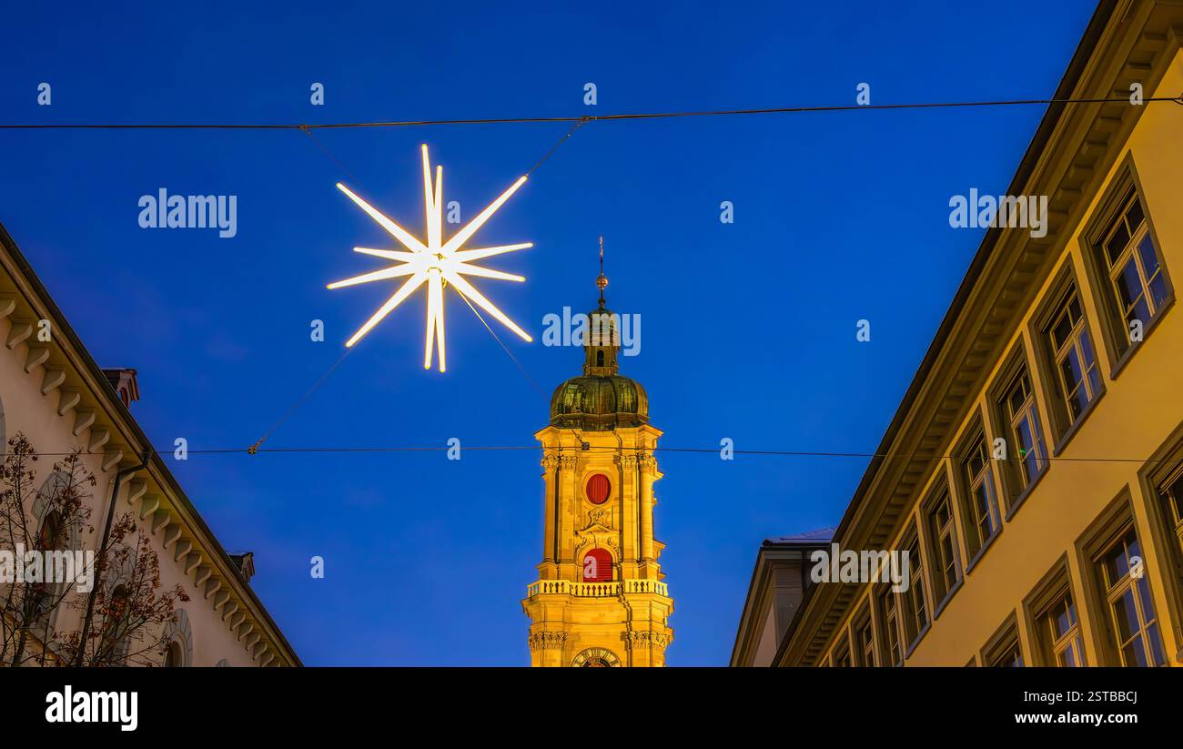 A bell tower of St. Gallus cathedral in St. Gallen illuminated at night ...