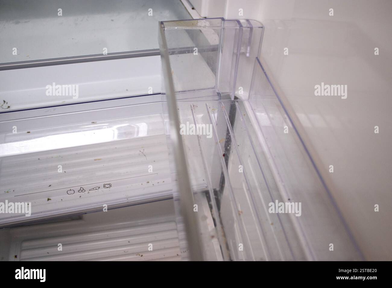 Close up of an open modern dirty refrigerator shelves that needs to be ...