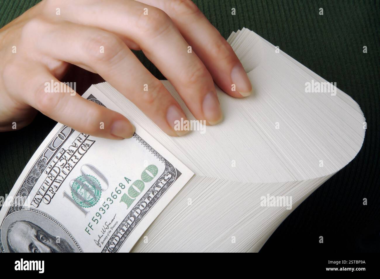 Woman fanning large stack of one hundred dollar dollar bills hi-res stock photography and images ...