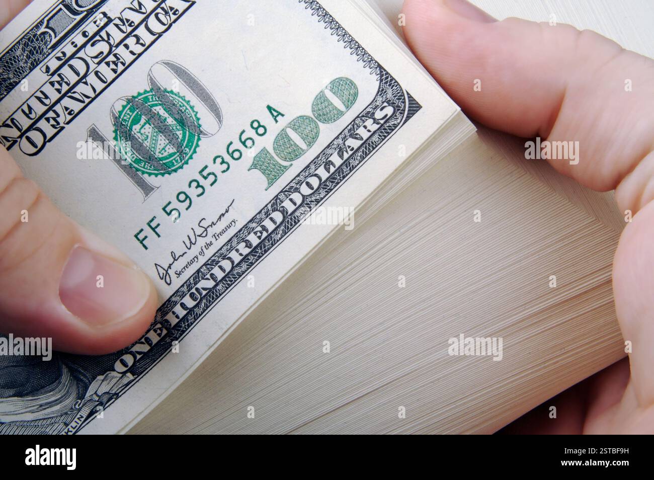 Man fanning large stack of one hundred dollar bills hi-res stock photography and images - Alamy
