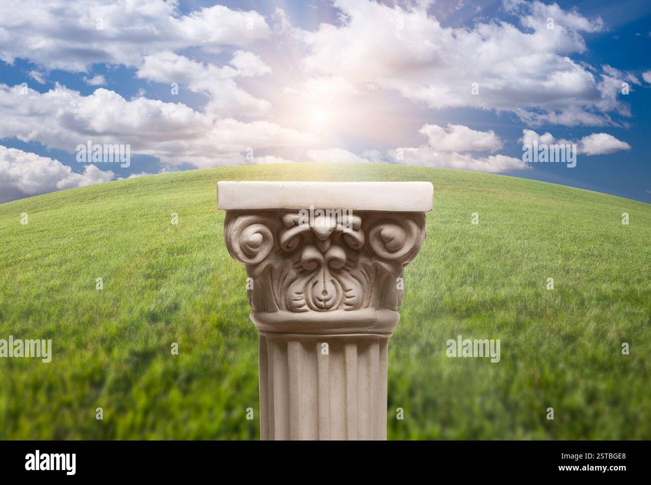 Ancient Replica Column Pillar Over Arched Horizon of Grass and Clouds ...