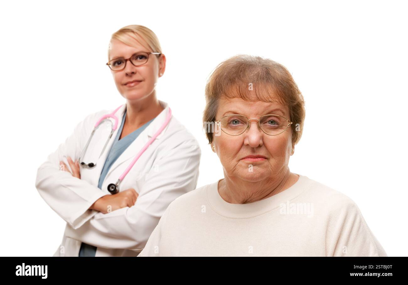 Concerned senior woman with doctor behind isolated on white background ...