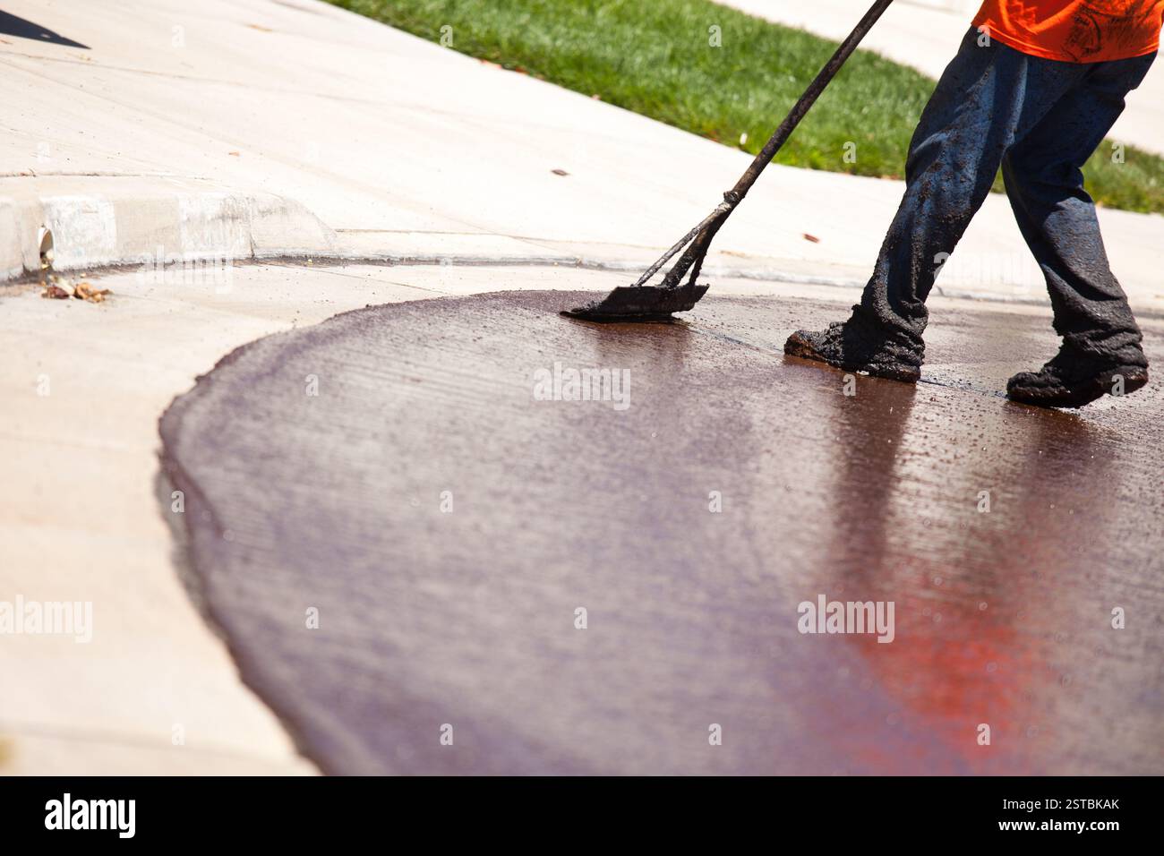 Road worker resurfacing street with hot tar hi-res stock photography ...