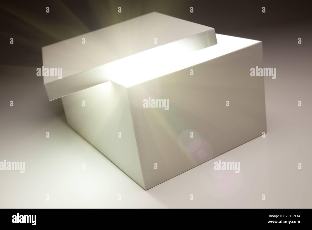 White Box with Lid Revealing Something Very Bright Stock Photo - Alamy