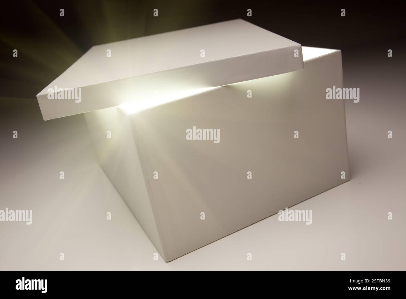White Box with Lid Revealing Something Very Bright Stock Photo - Alamy