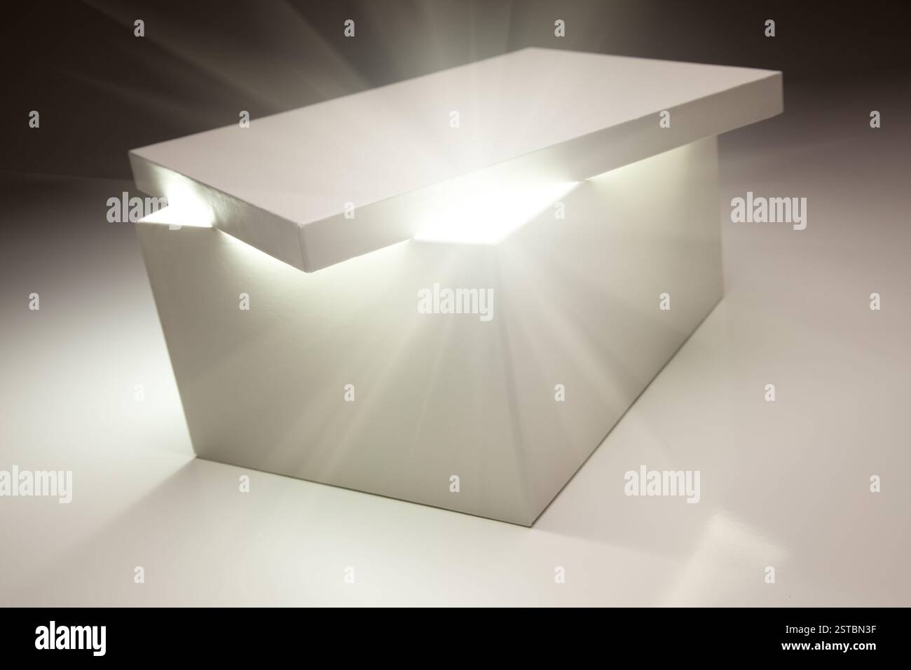 White Box with Lid Revealing Something Very Bright Stock Photo - Alamy