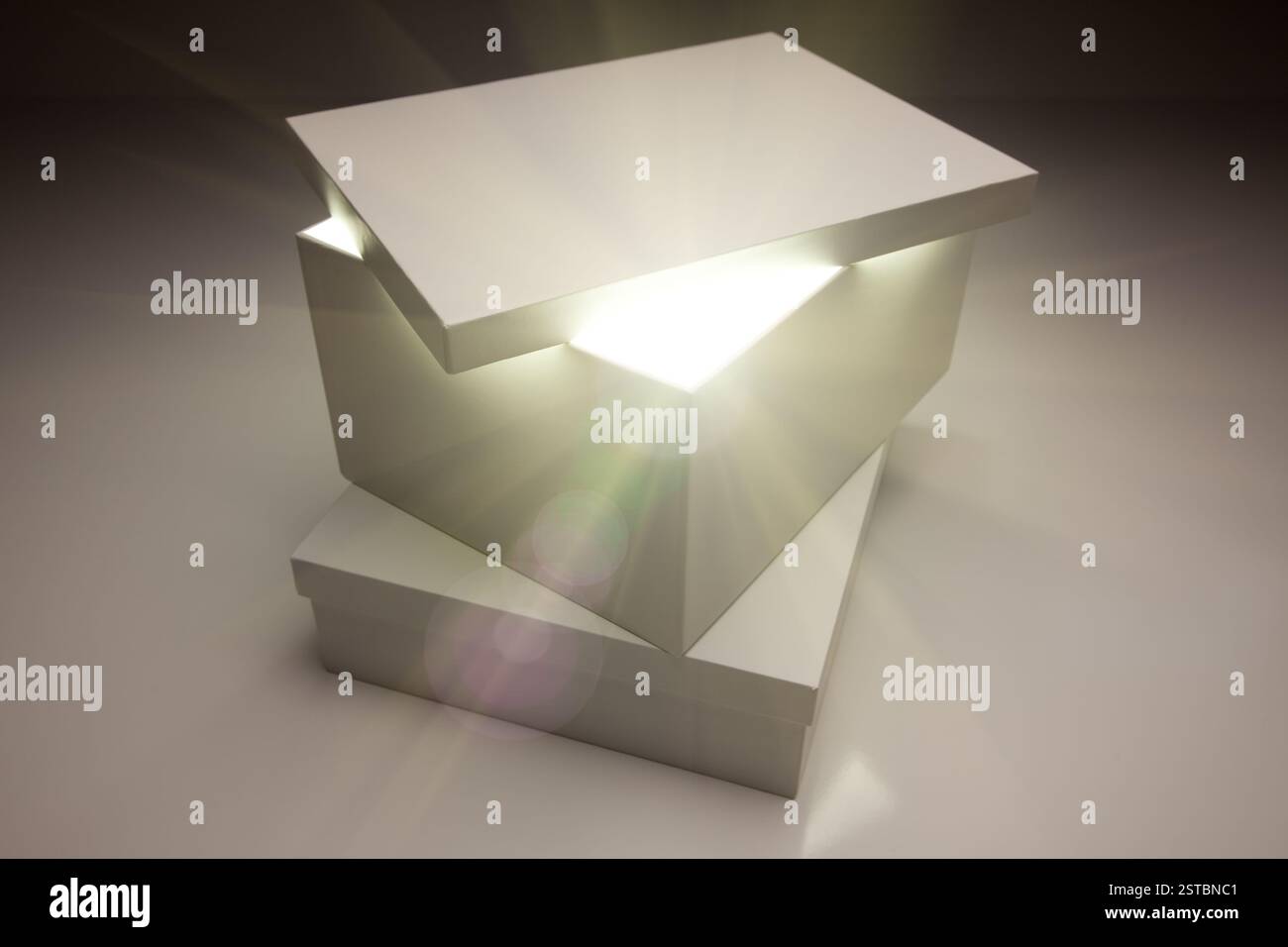 White Box with Lid Revealing Something Very Bright Stock Photo - Alamy