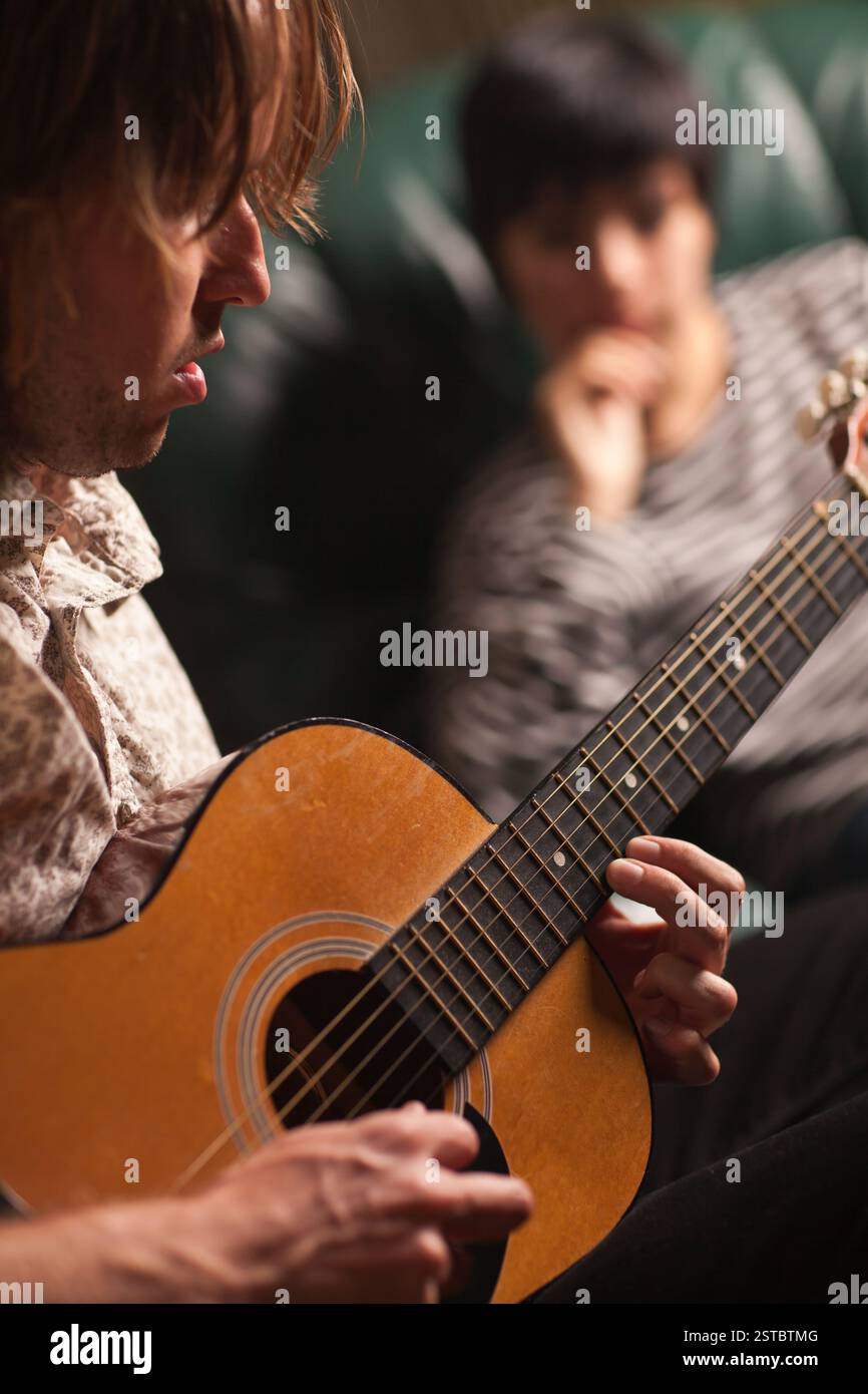 Young Musician Plays His Acoustic Guitar as Friend Listens Stock Photo ...
