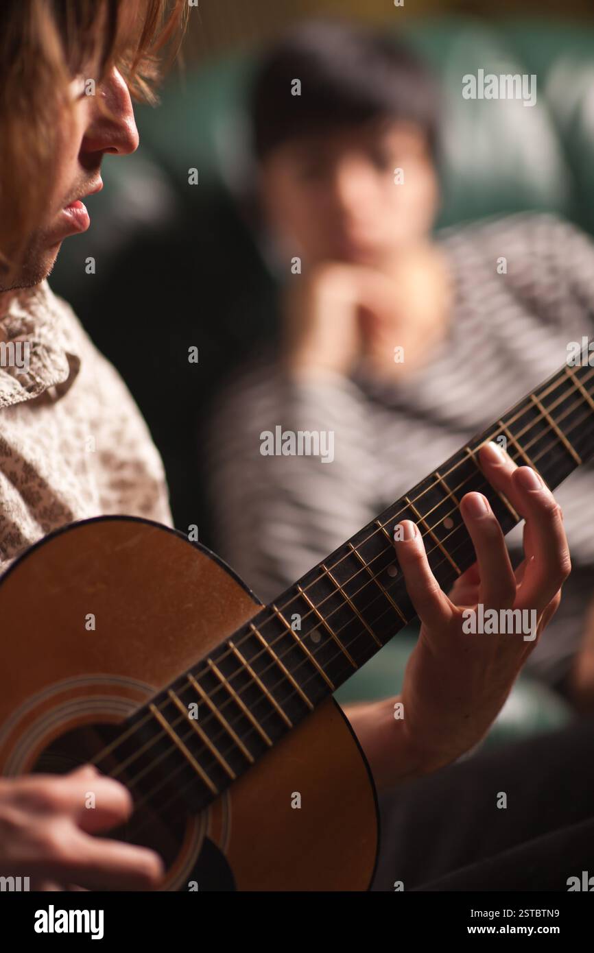 Young Musician Plays His Acoustic Guitar as Friend Listens Stock Photo ...