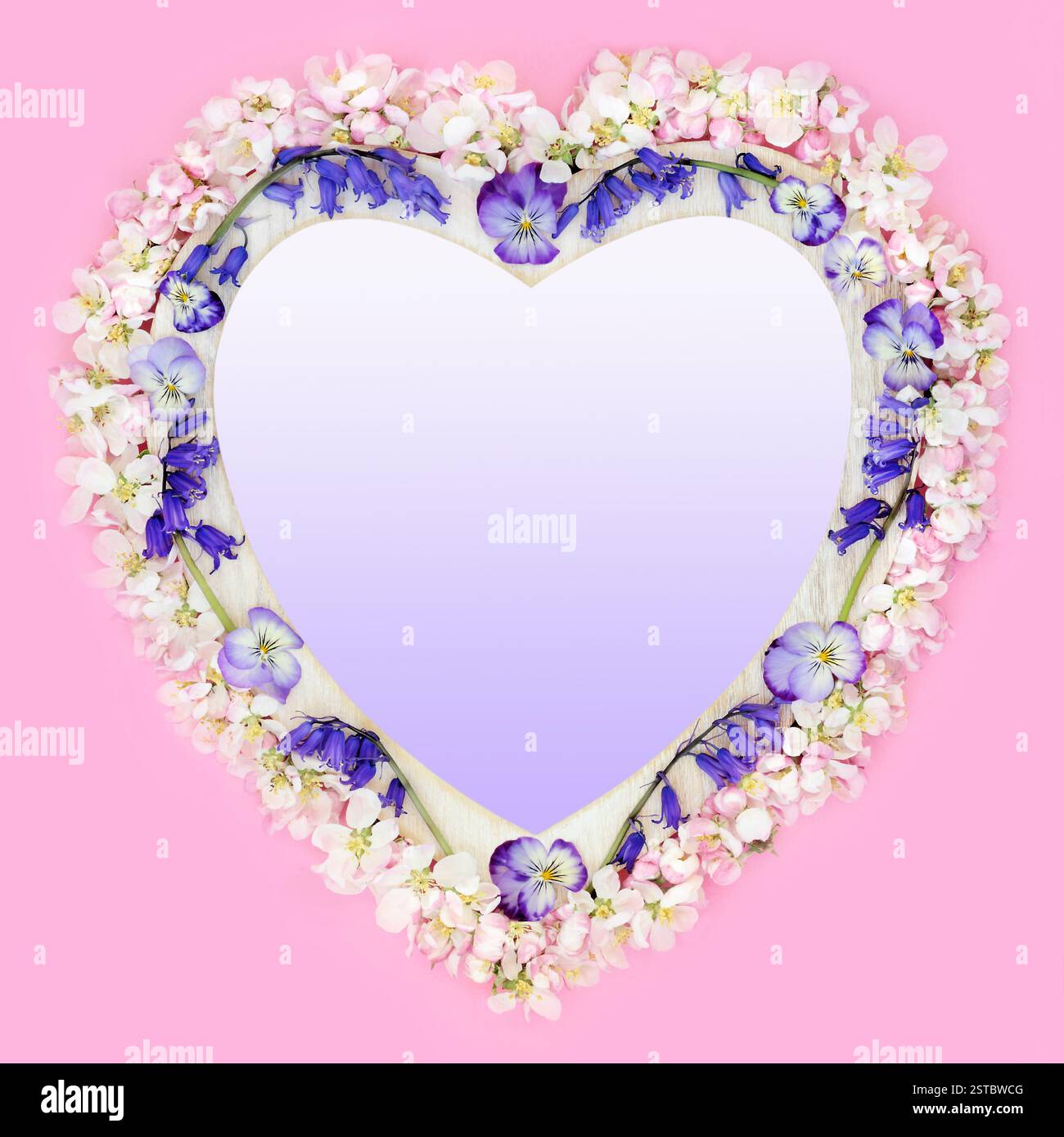 Heart shape Spring Beltane wreath with blossom flowers on pink ...