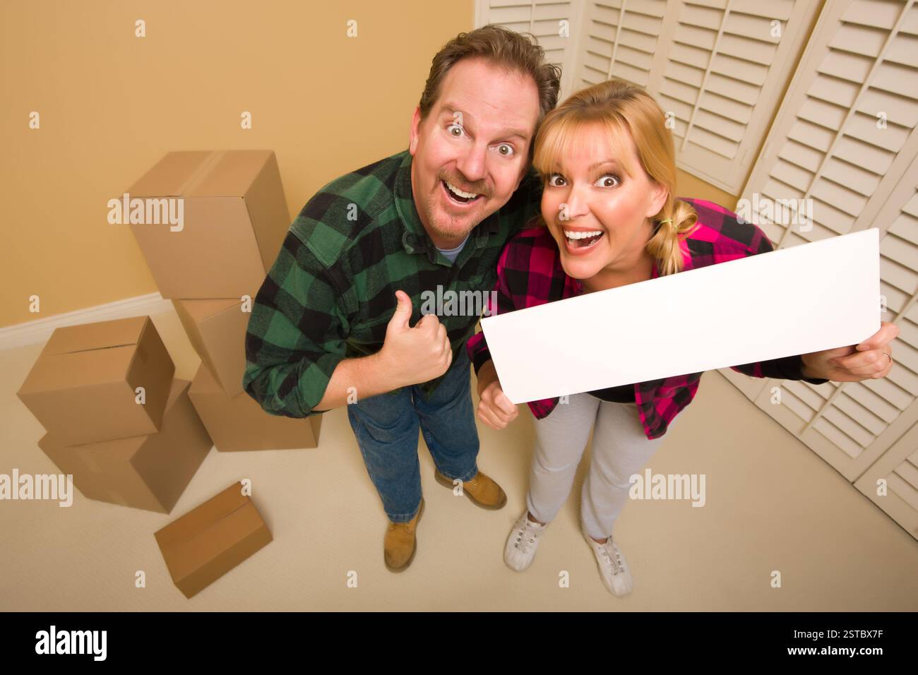 Goofy Goofy Thumbs Up Couple Holding Blank Sign Surrounded by Boxes ...