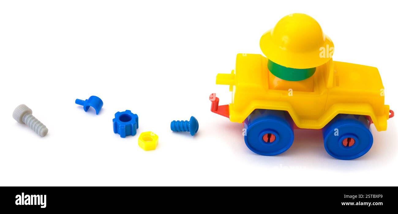 Yellow plastic toy machine with blue wheels hi-res stock photography ...