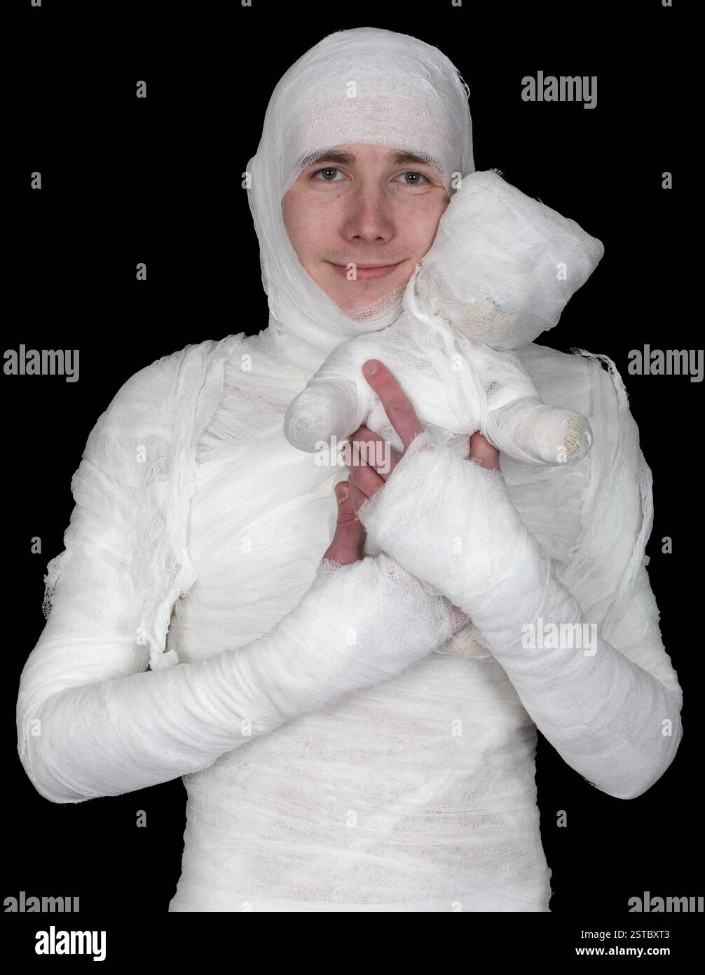 Sentimental man in bandage with mummy bear on black Stock Photo - Alamy