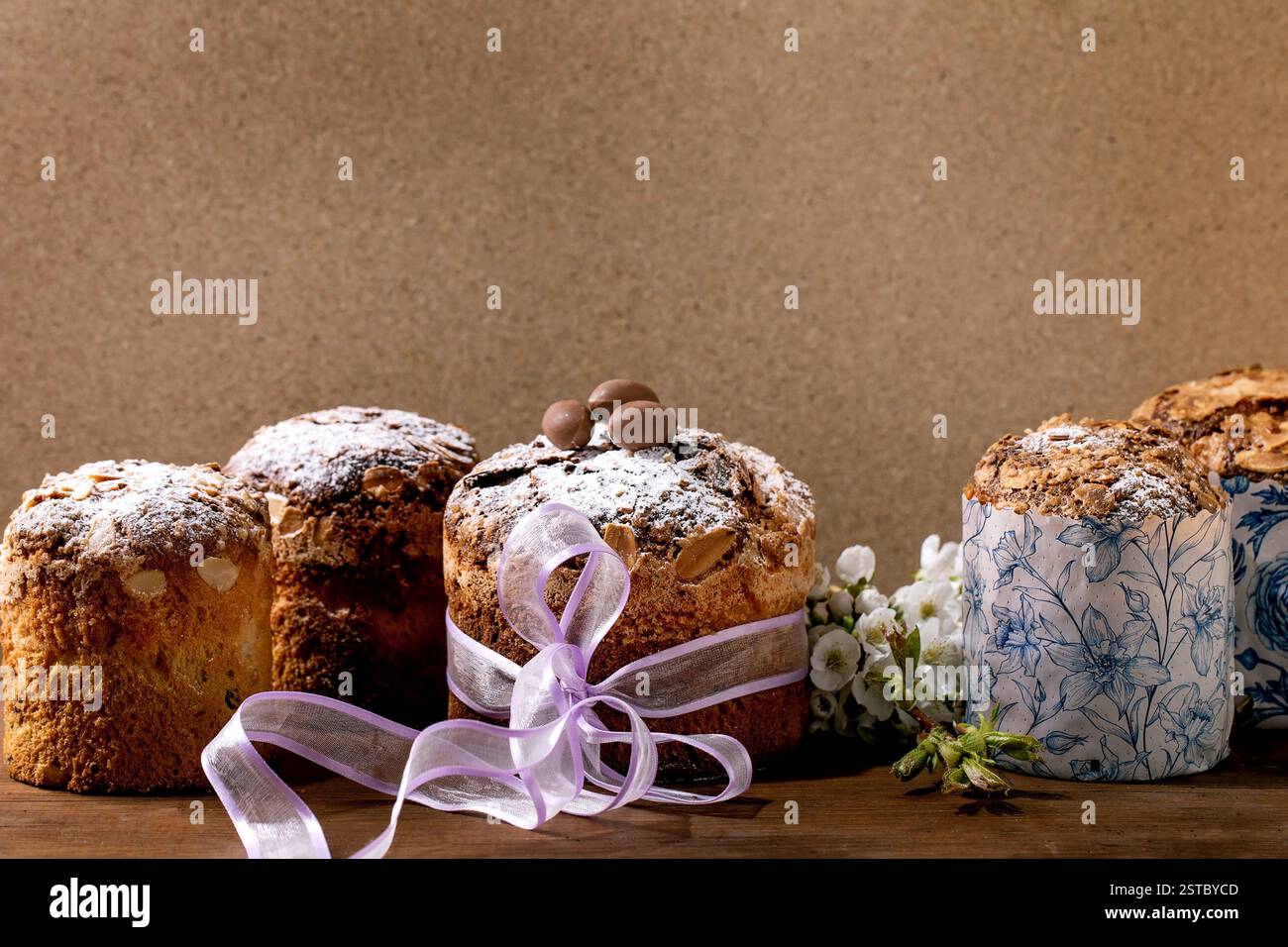 Homemade Italian traditional Easter panettone cakes in row, decorated ...